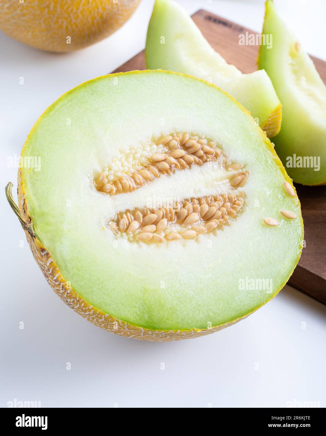 Half melon and sliced pieces of melon on white background Stock Photo ...