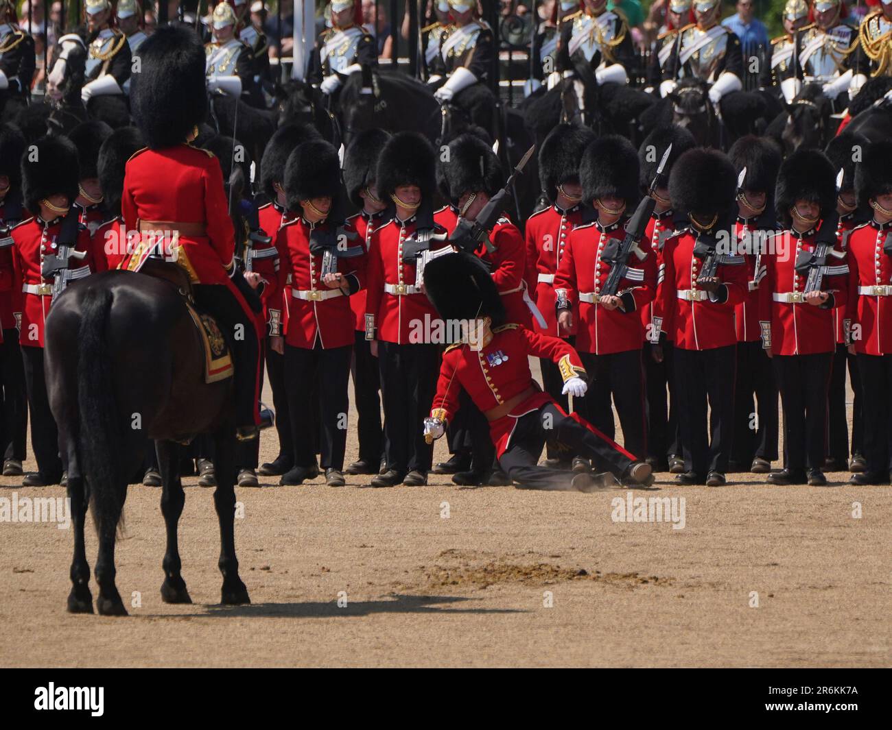 Image 4 of 8 in a sequence showing a member of the military fainting ...