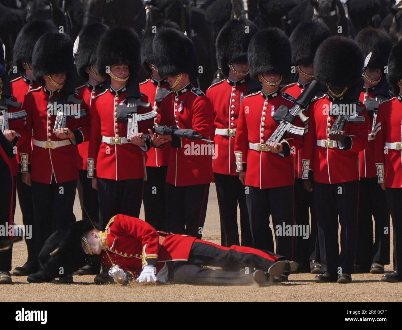 Image 6 of 8 in a sequence showing a member of the military fainting ...