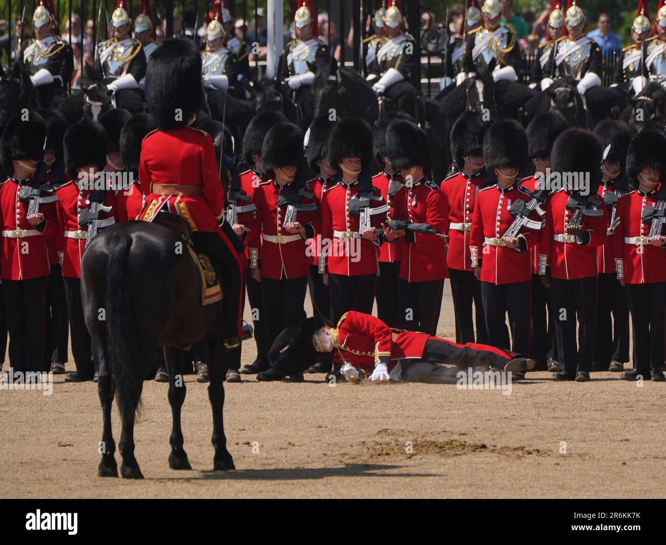 Image 7 of 8 in a sequence showing a member of the military fainting ...