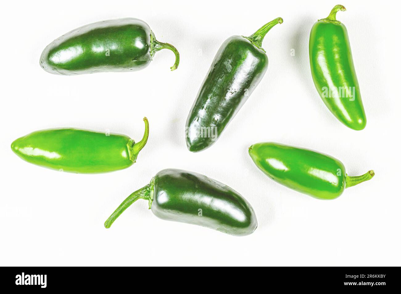 The green peppers resting on a plain white background Stock Photo - Alamy