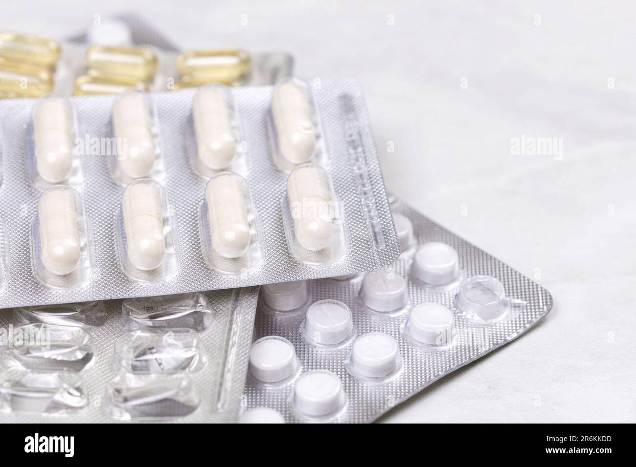 A collection of medicine packets with white and yellow pills Stock ...
