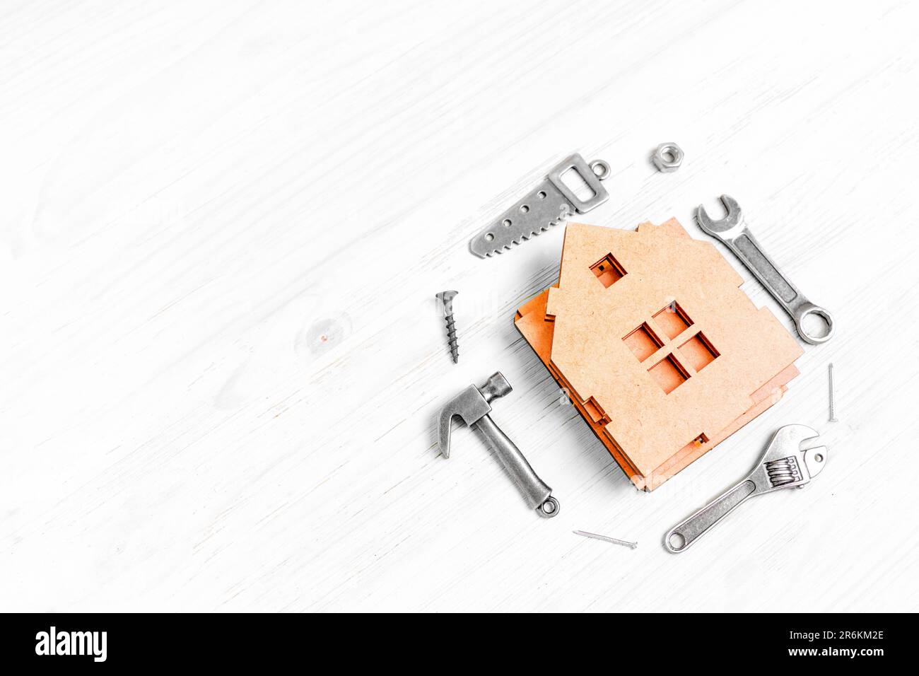 Wooden house parts and tiny steel hand tool replicas with fasteners ...