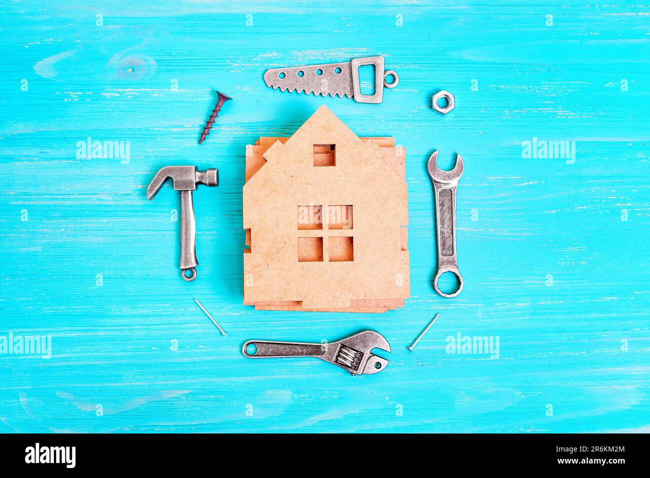 Set of tiny replicas of the essential hand tools and fasteners arranged ...