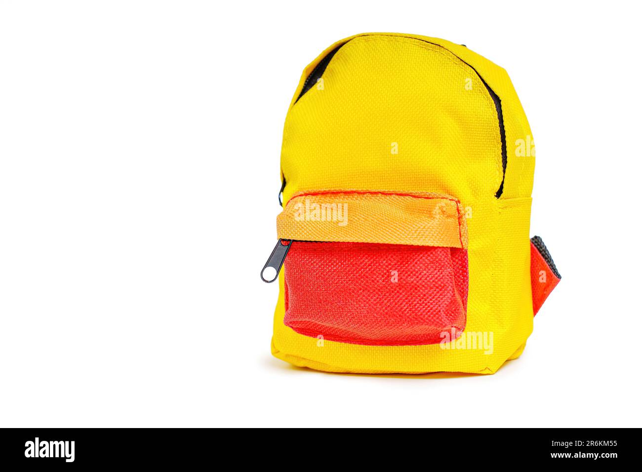 A vibrant and compact yellow and red backpack isolated on white ...