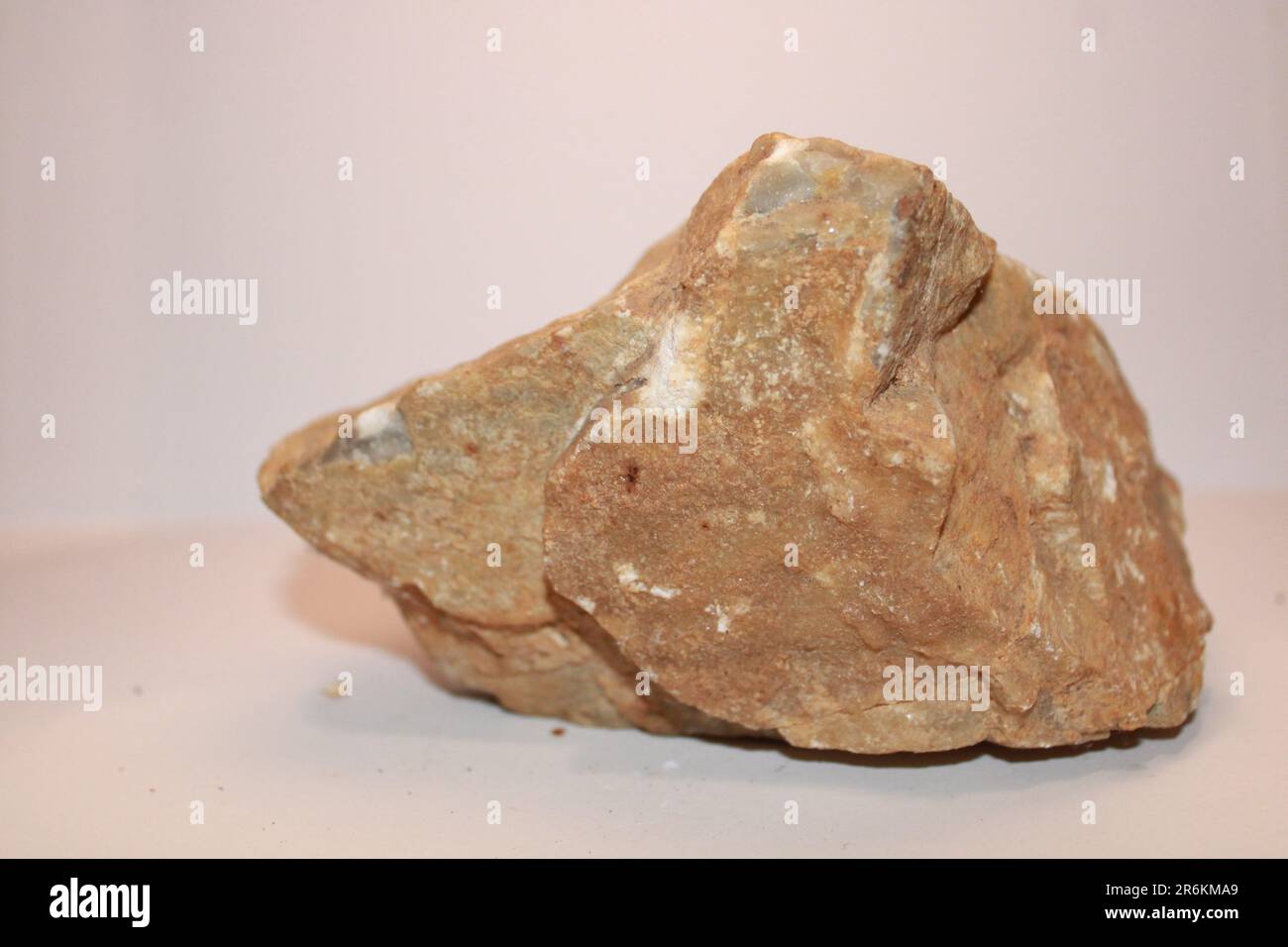 A natural rock formation characterized by an uneven surface and covered ...