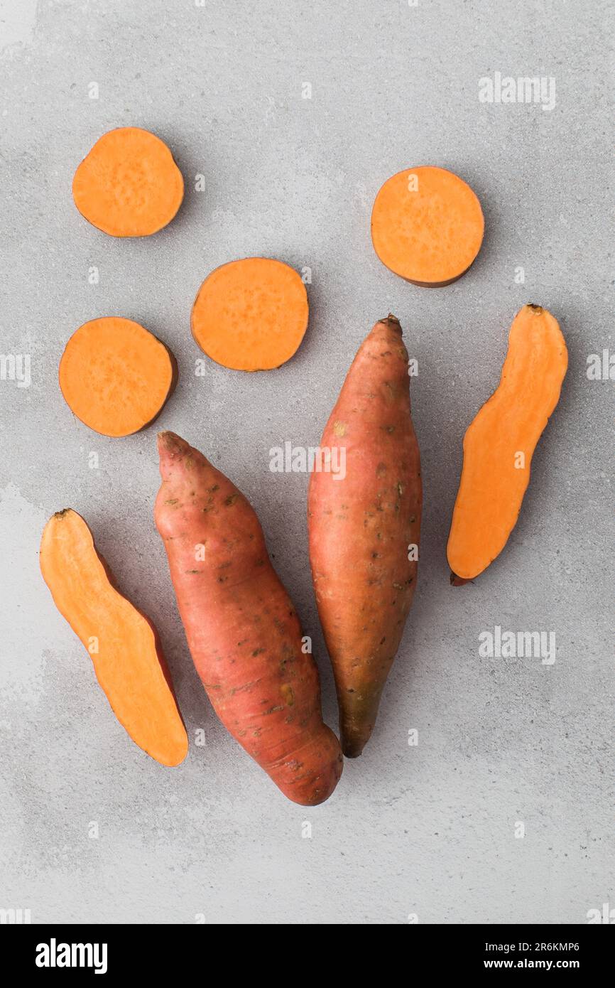 Raw sweet potatoes whole and cut. Orange kumara, sweet potato ...