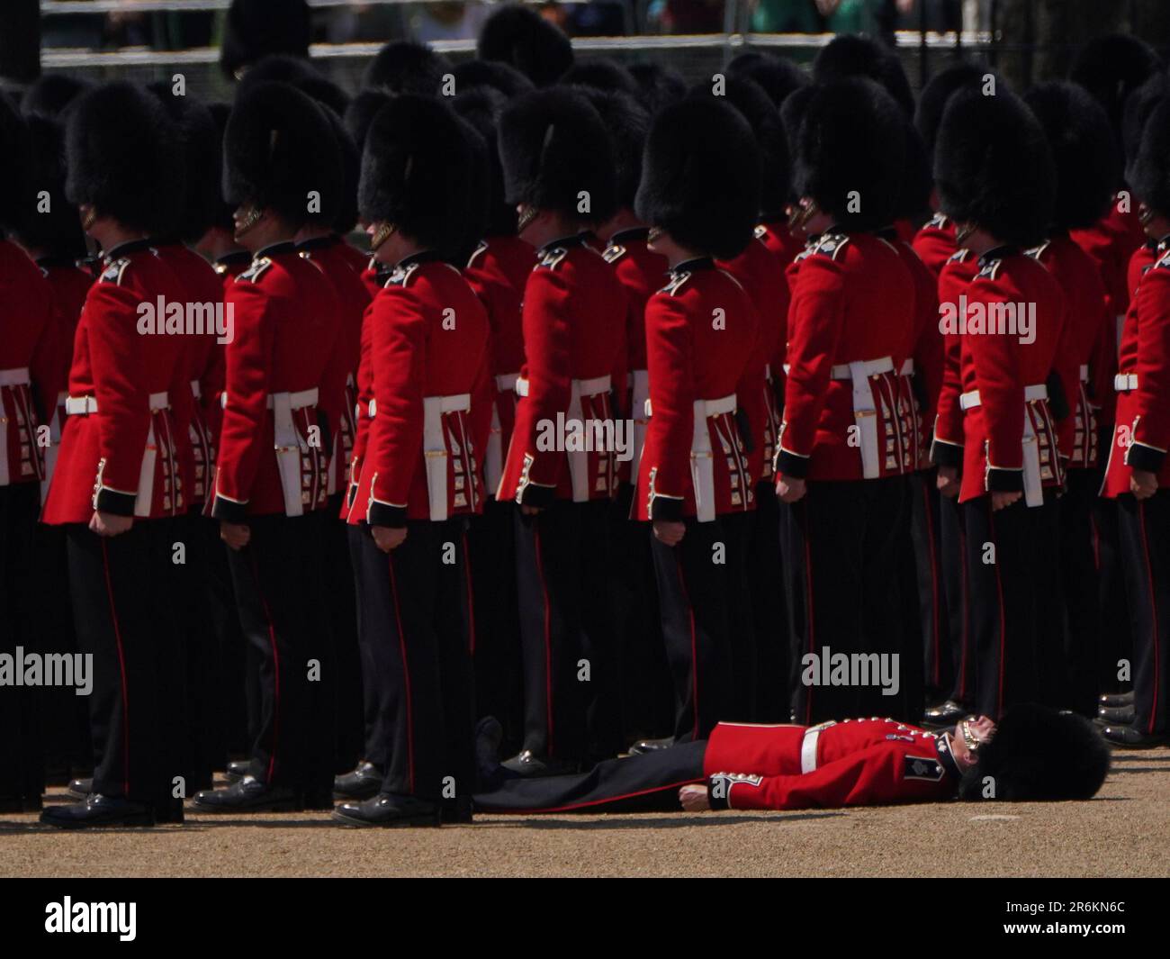 A member of the military fainting due to the heat during the Colonel's ...