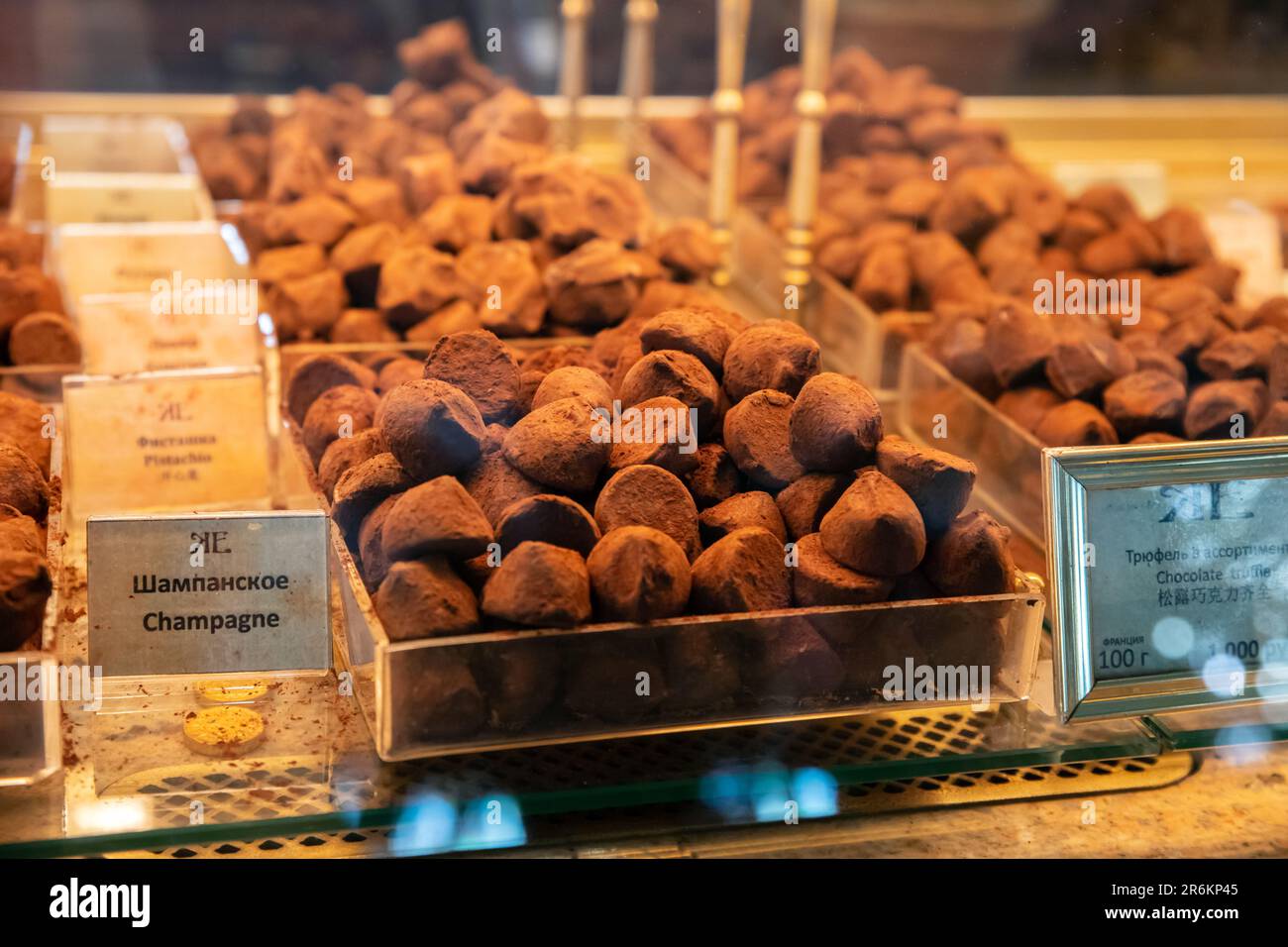 Chocolate truffles bites covered with cocoa a lot on shop window. Heap ...