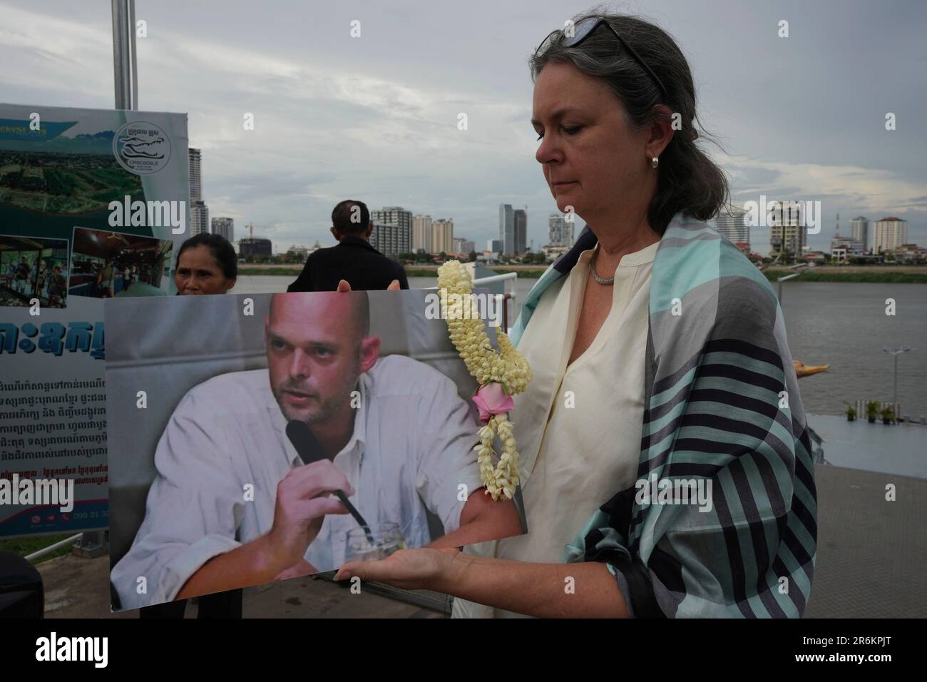 Linda K. Stubbs carries a portrait of her brother-in-law Nate Thayer ...