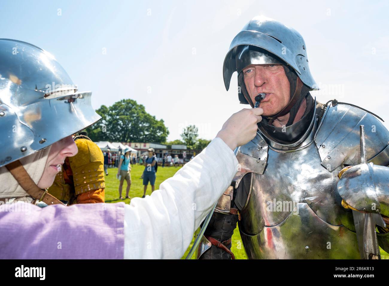 London, UK. 10 June 2023. A re-enactor in armour receives a drink in ...
