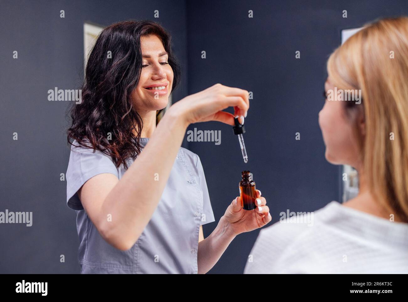 Pretty caucasian beautician communicates with her female client. Beauty ...