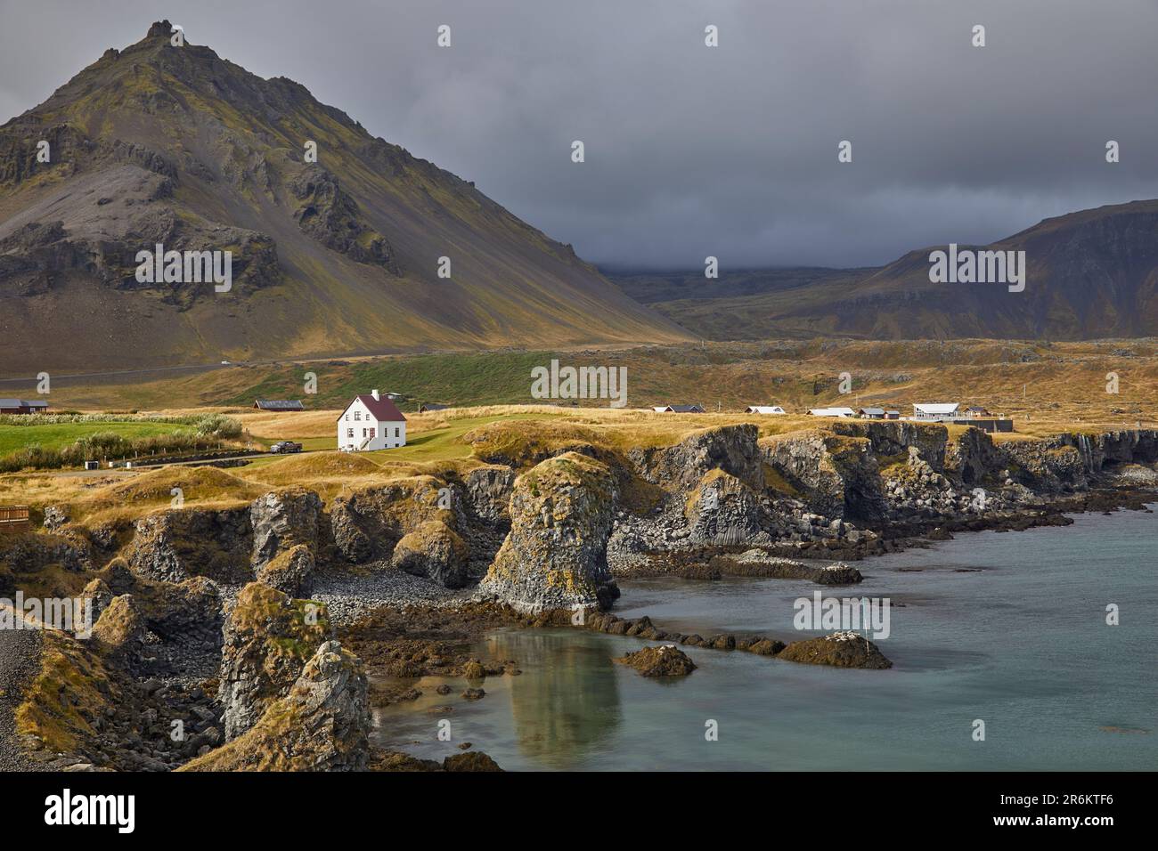 A classic view of the basalt lava cliffs on the coast at the village of ...