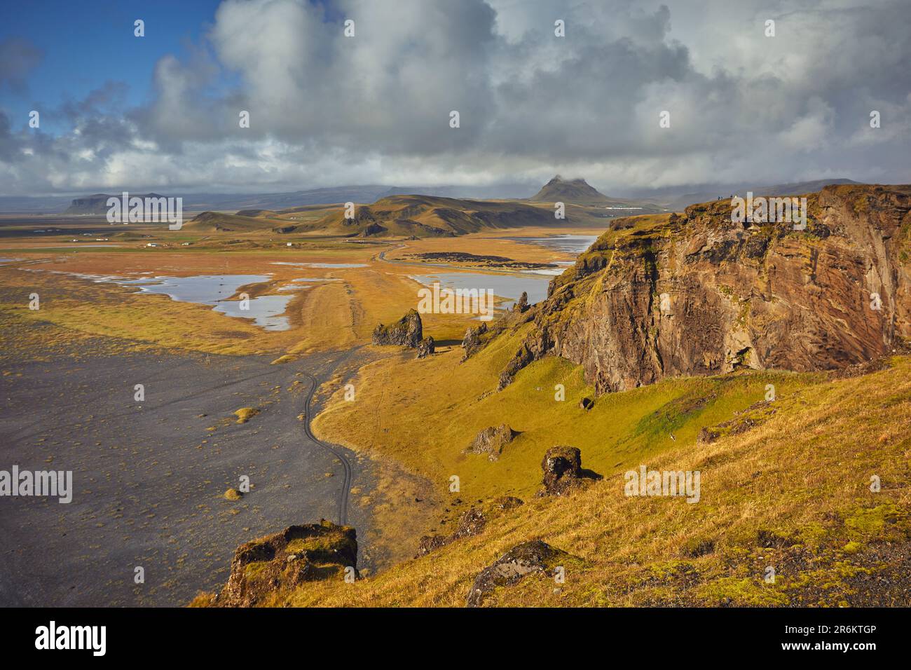 A rugged rocky and watery landscape around Dyrholaey Island, near the ...
