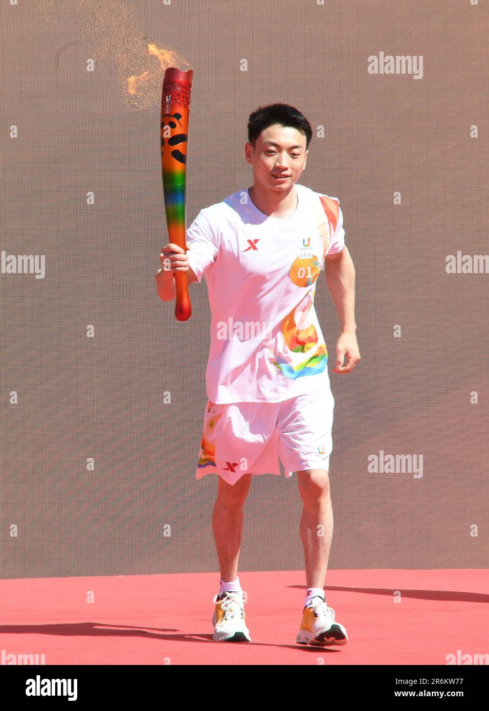 Beijing, China. 10th June, 2023. Torch bearer Zou Jingyuan runs with ...