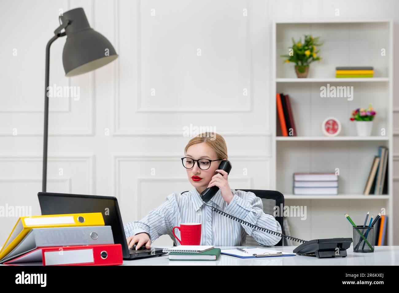 secretary cute lovely blonde young girl in shirt in office with work ...