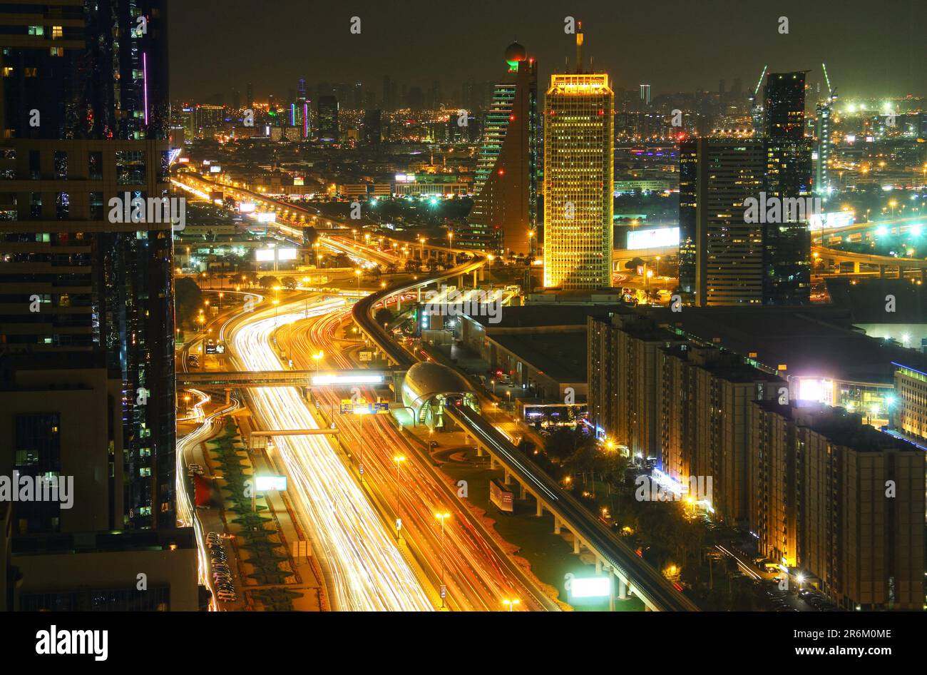 A stunning nighttime cityscape featuring an illuminated street with a ...