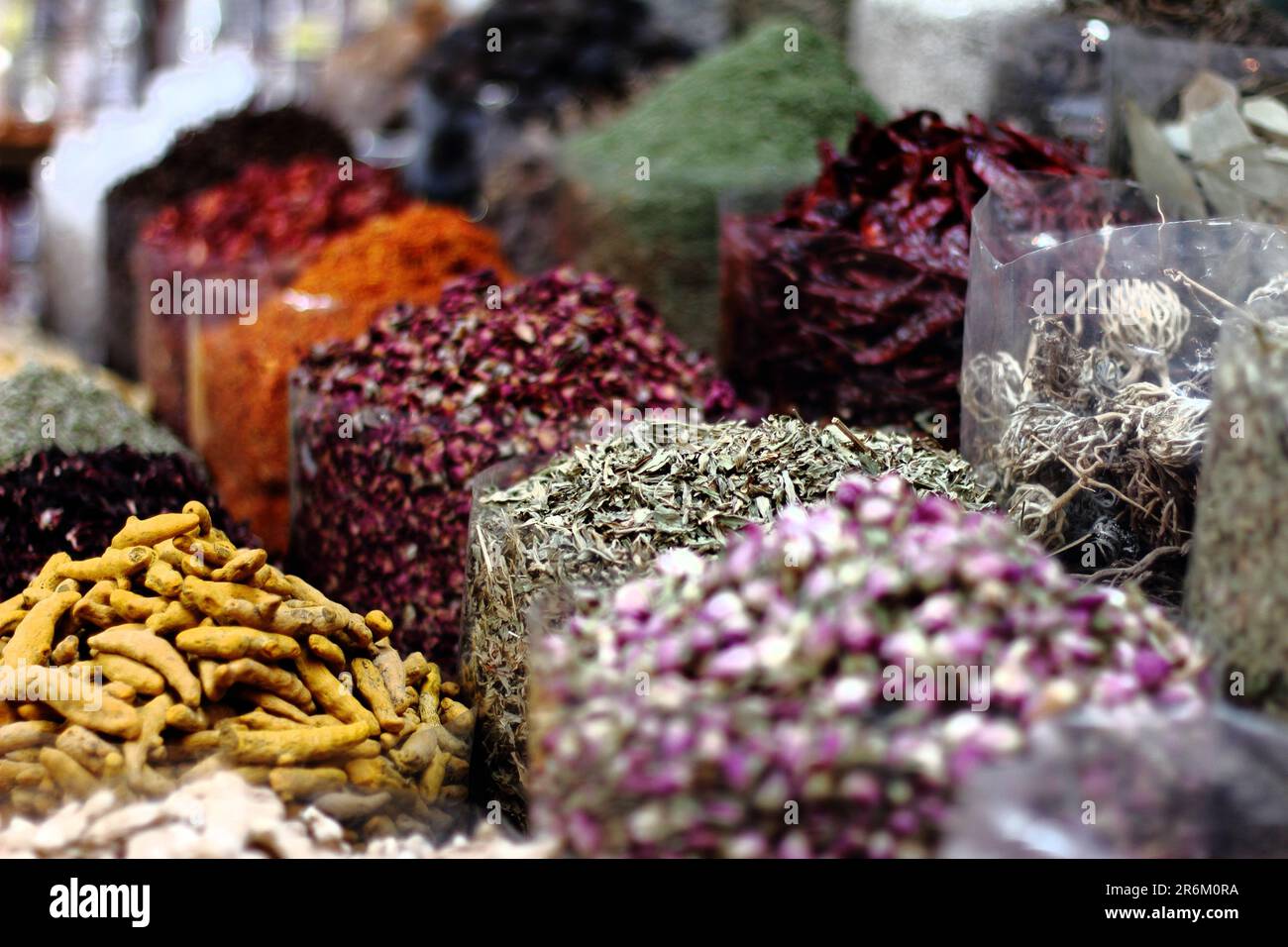 An array of colorful spices on display, arranged in a decorative ...