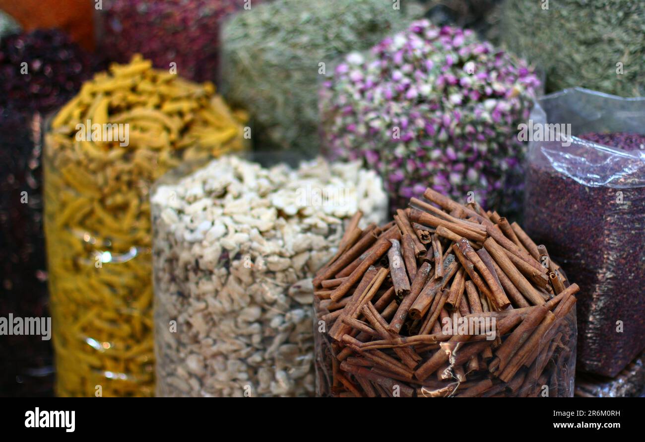 An assortment of dried herbs in various quantities arranged in a neat ...