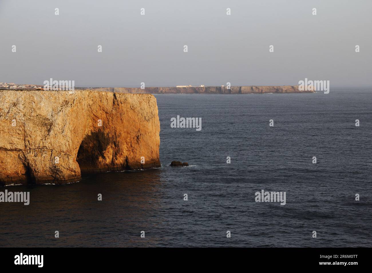 A stunning rock cliff formation situated at the edge of the shoreline ...