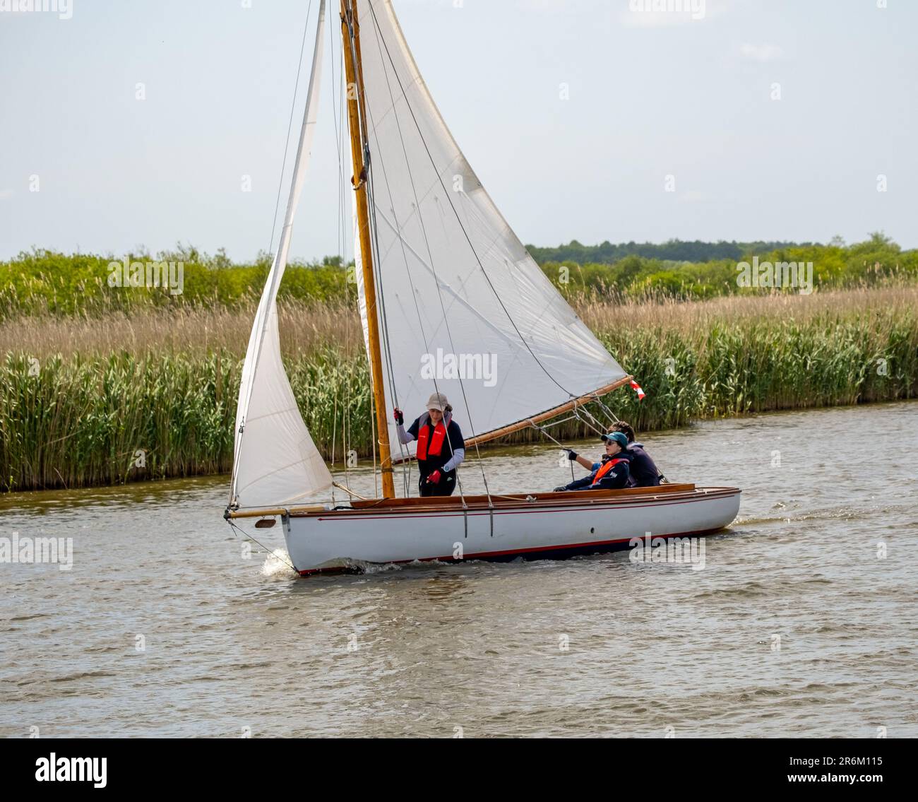 Horning, Norfolk, UK – June 03 2023. Three sailors competing in the ...