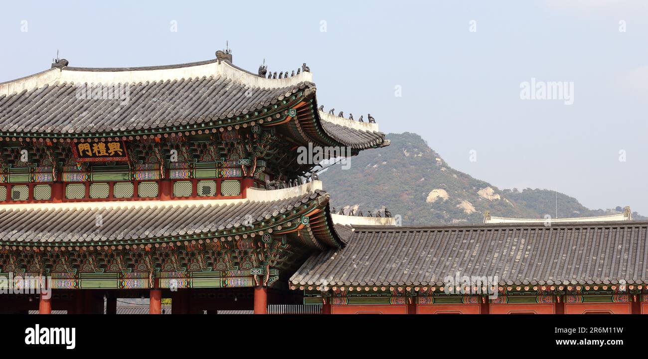 Several people in casual attire walking in front of a traditional Asian ...