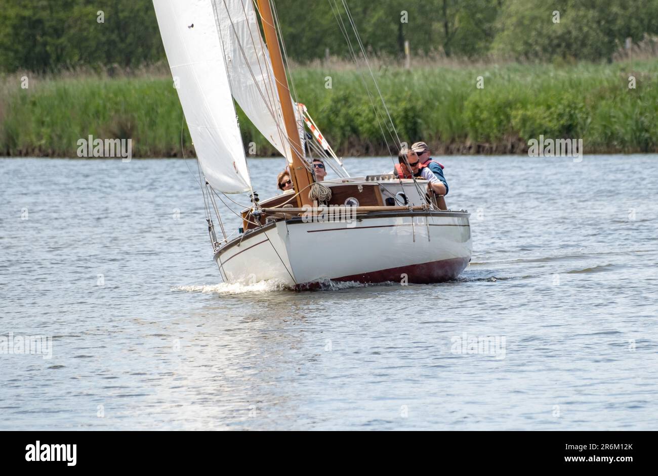 Front on view of a wooden cruiser sailing down the River Bure, Norfolk ...