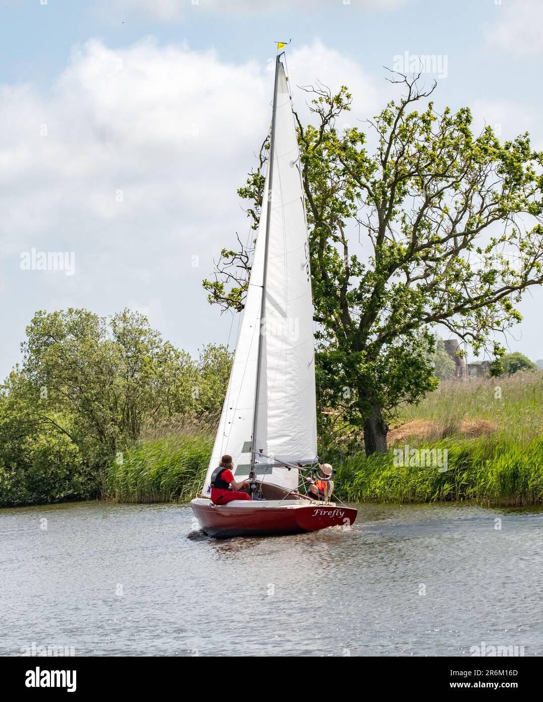 Two sailors racing a small sailboat in the annual Three Rivers Race ...