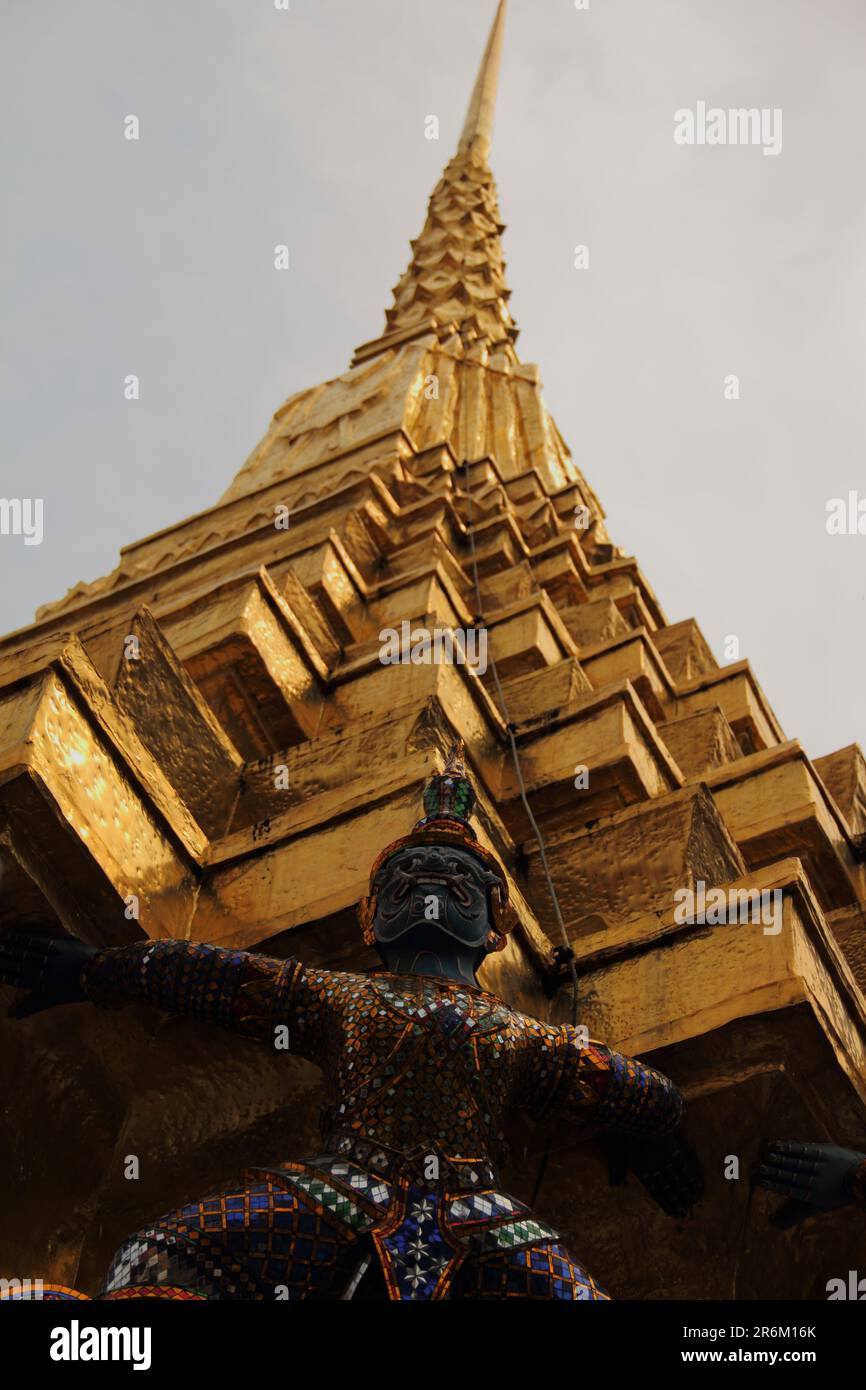 A majestic monument stands in the foreground of a tall, ornate ...