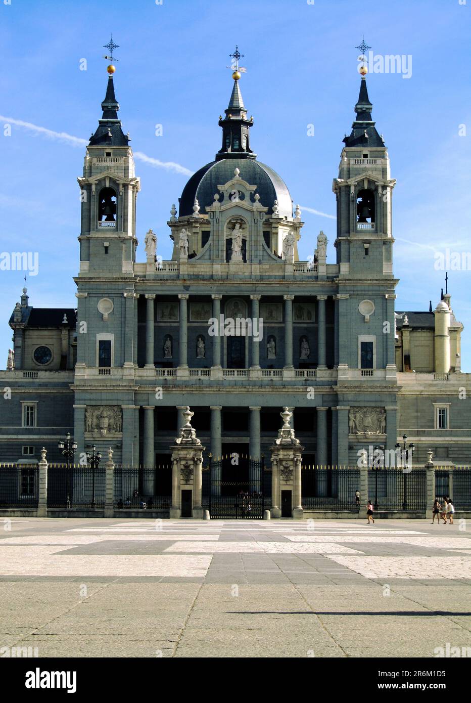A picturesque church featuring multiple towers with statues of people ...