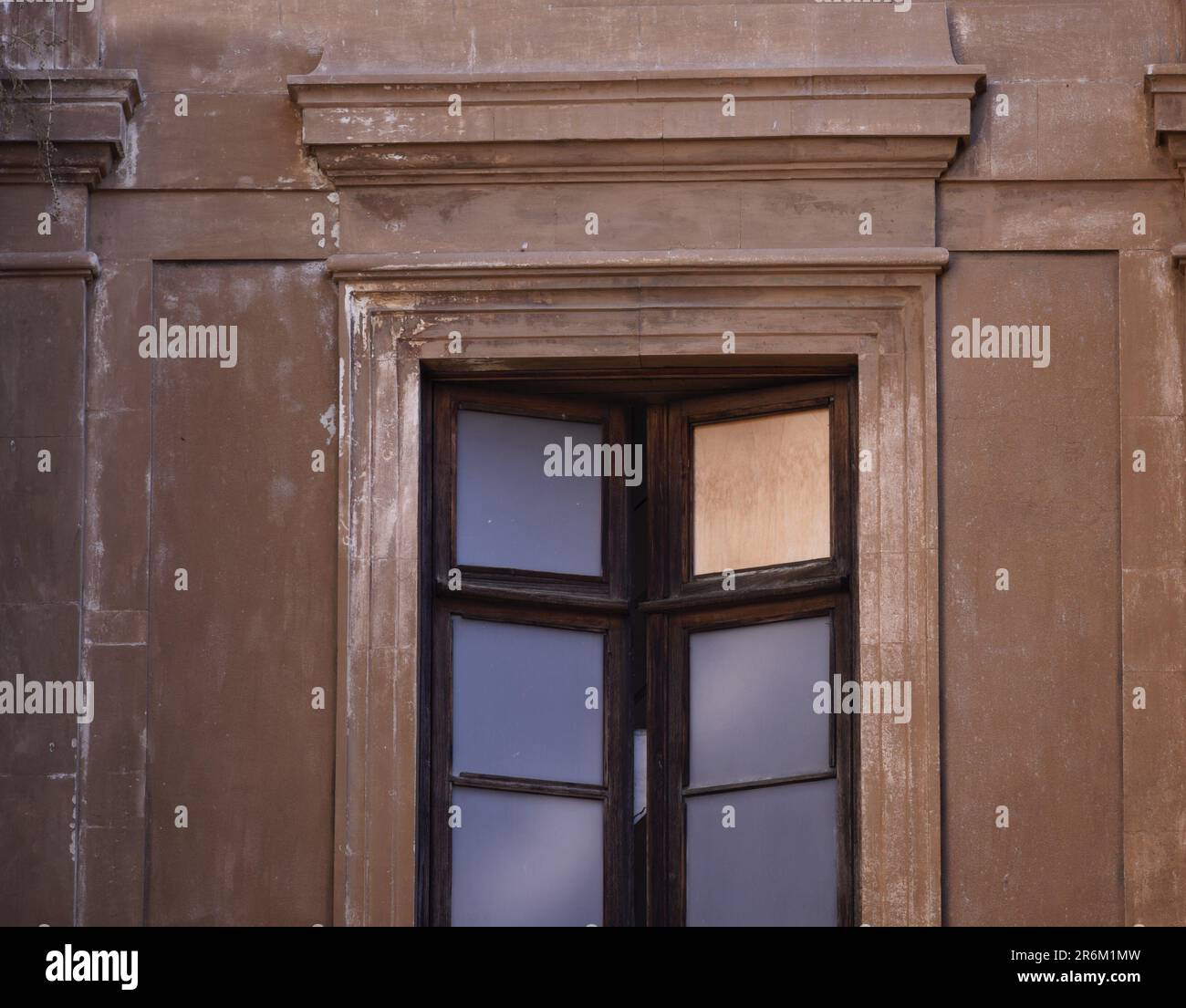 Old Neoclassical building wooden window with reflections against a ...