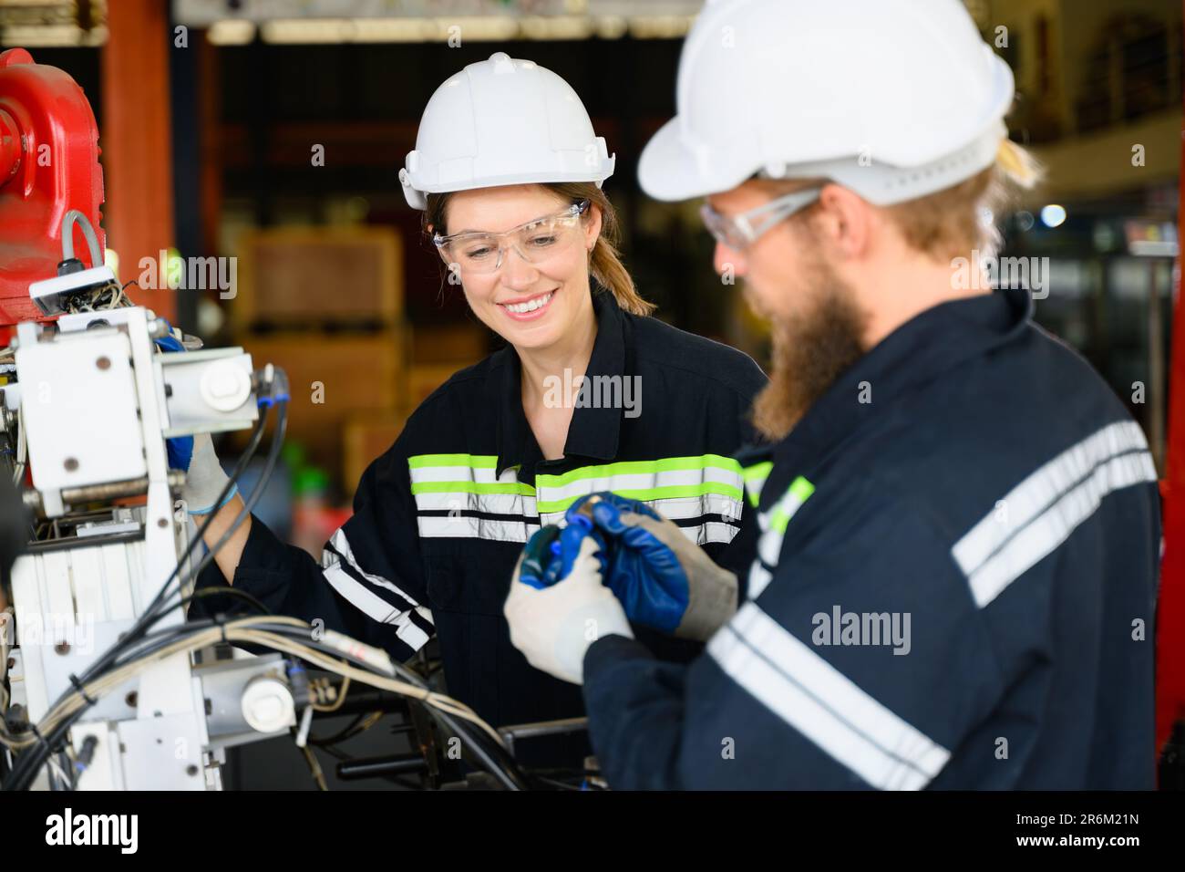 Mechanical engineers repairing engine machine at factory Stock Photo ...