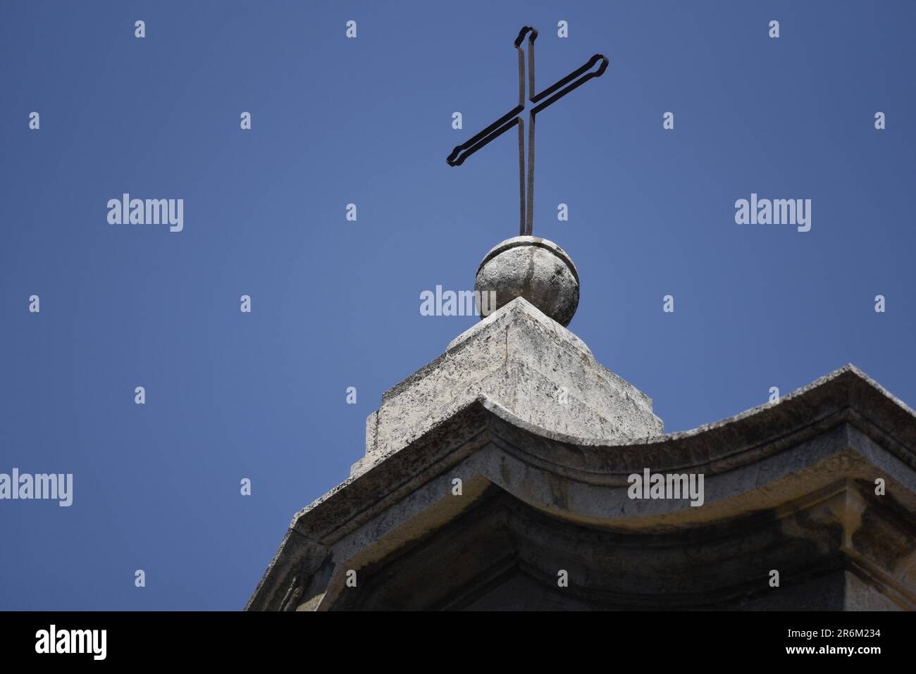Wrought iron cross on the limestone exterior of the Sicilian Baroque ...