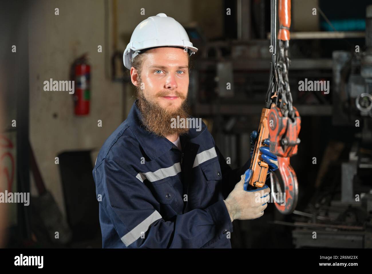 Mechanical engineer repairing engine machine at factory Stock Photo - Alamy