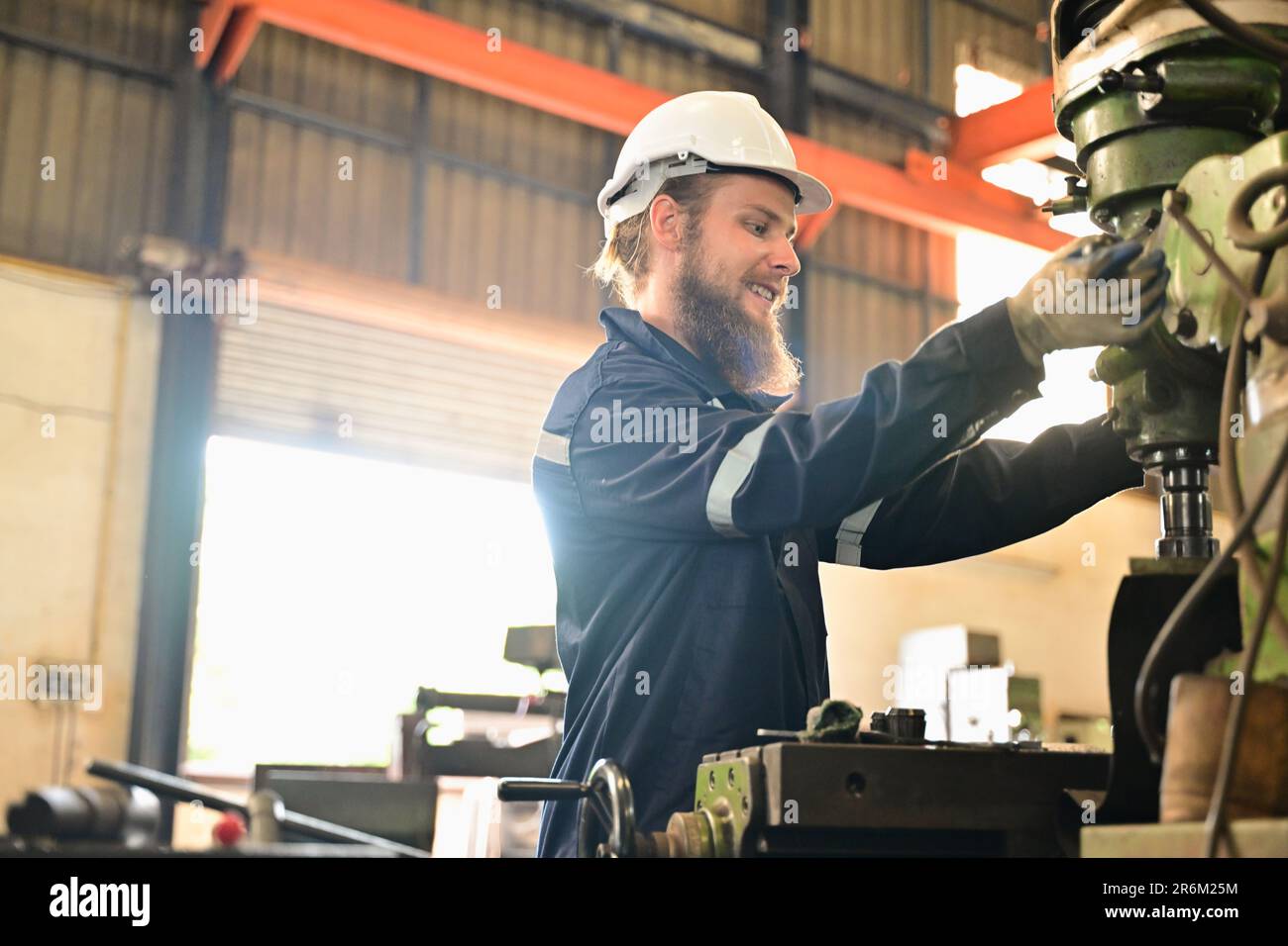 Mechanical engineers repairing engine machine at factory Stock Photo ...
