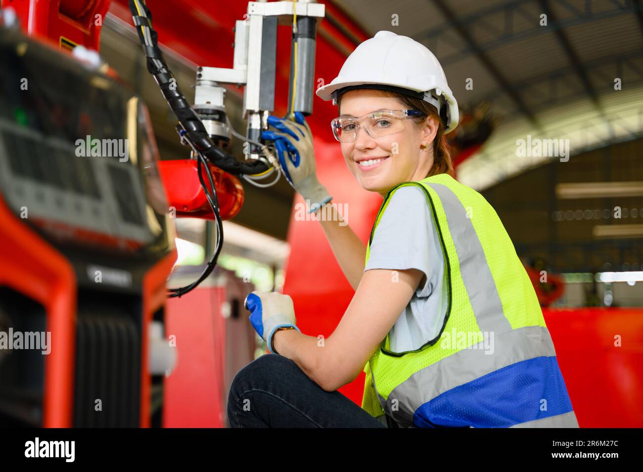 Mechanical engineer repairing engine machine at factory Stock Photo - Alamy