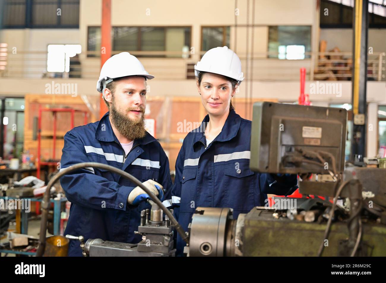 Mechanical engineers repairing engine machine at factory Stock Photo ...