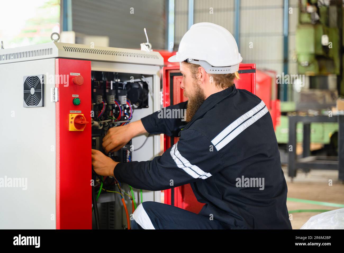 Mechanical engineer repairing engine machine at factory Stock Photo - Alamy