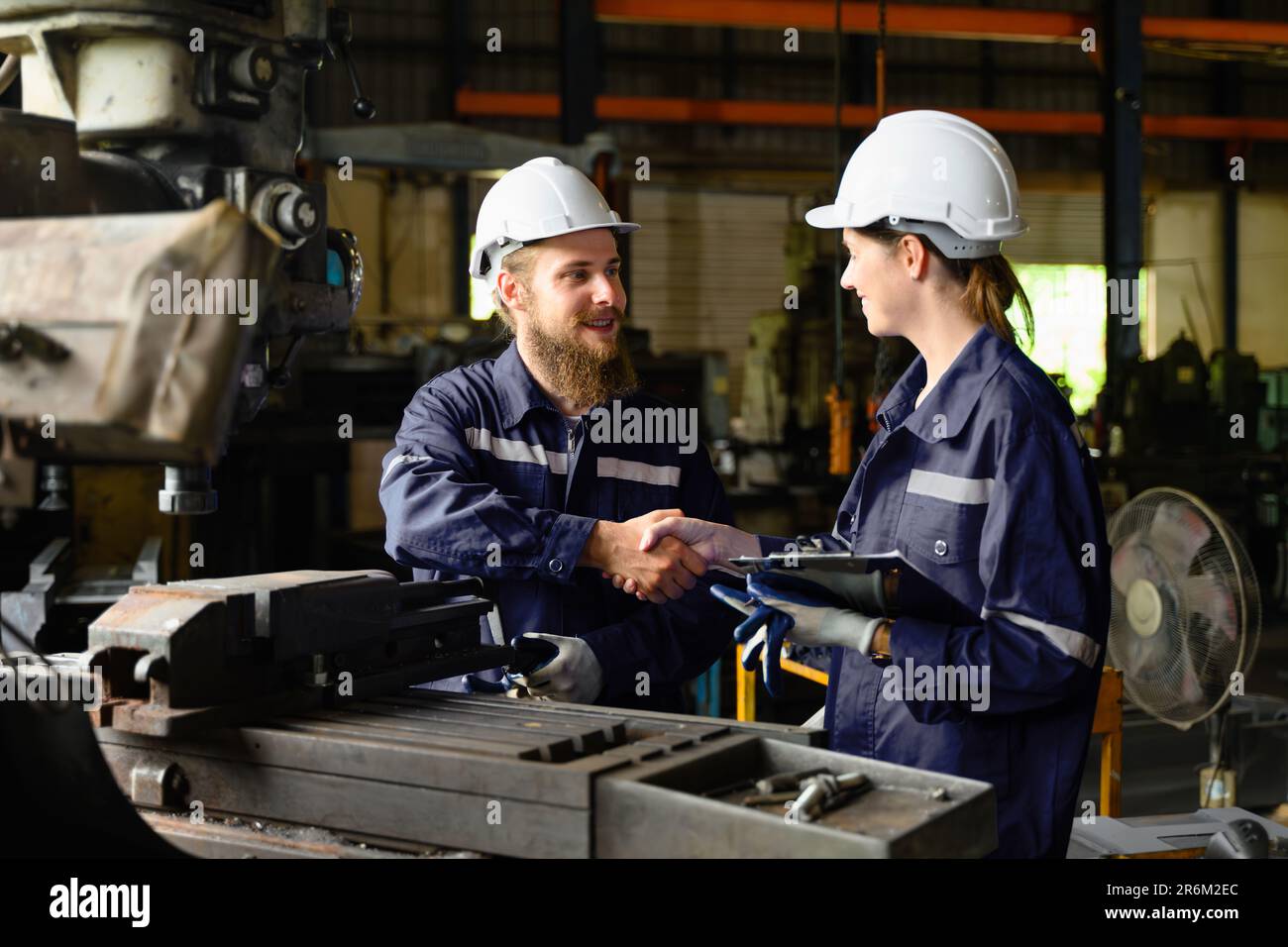 Mechanical engineers repairing engine machine at factory Stock Photo ...