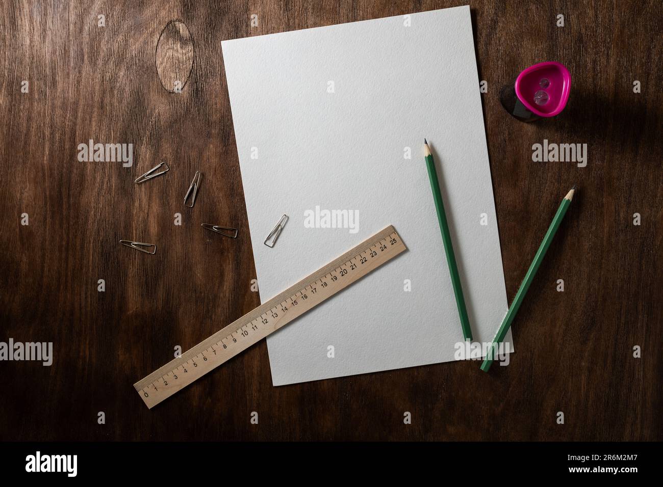Still life with pencils, scraper paper and pencil sharpener on a dark ...