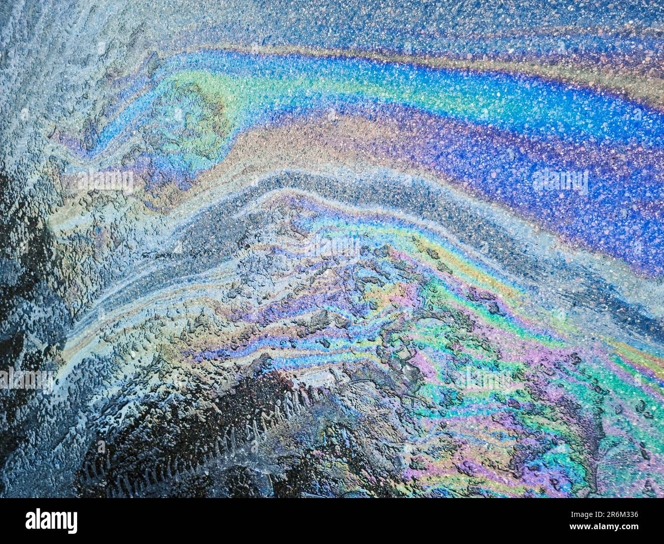 Colorful oil stains on asphalt in parking lot Stock Photo - Alamy
