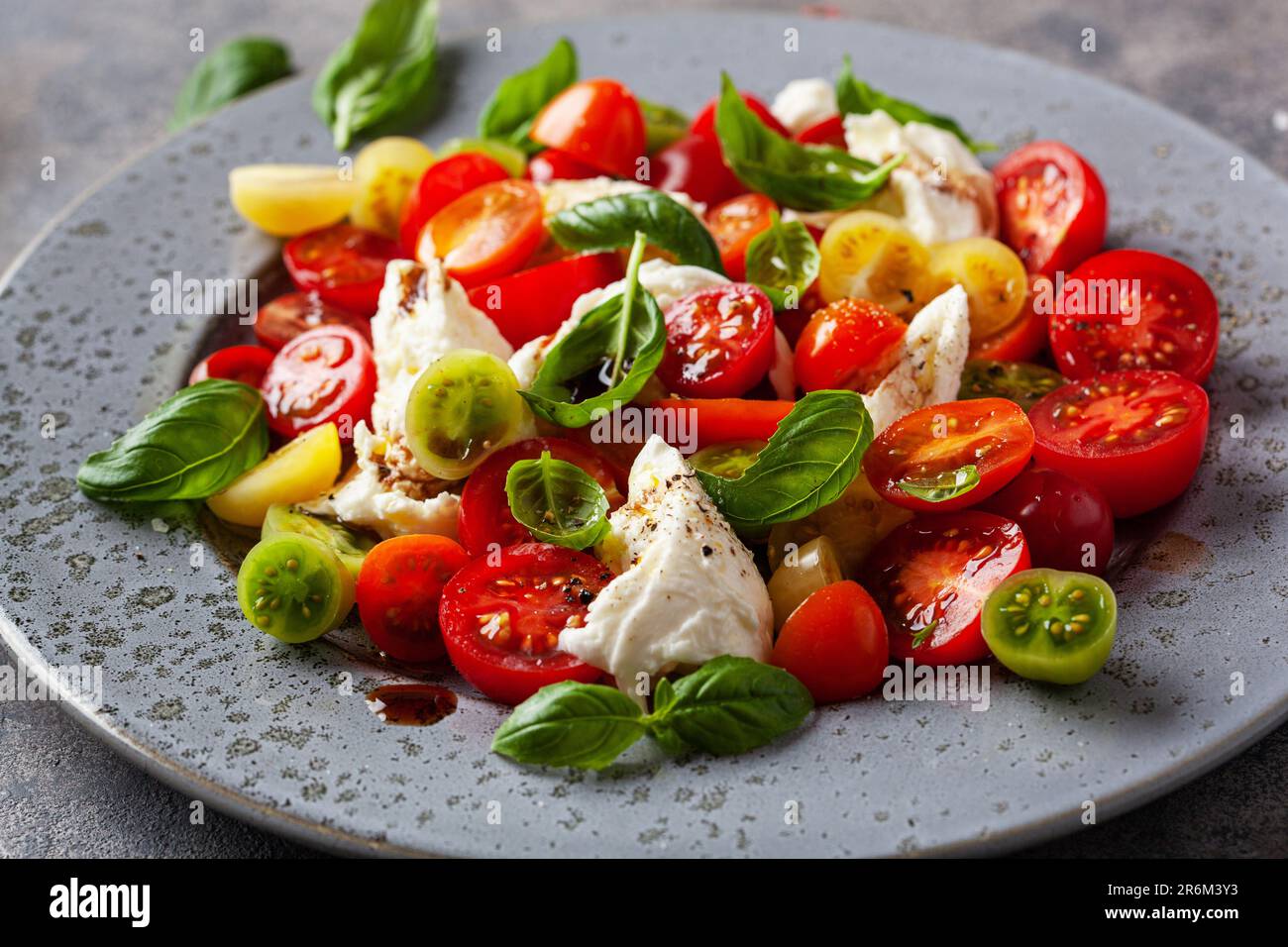 healthy colorful tomato mozzarella basil salad with balsamic vinegar dressing Stock Photo - Alamy