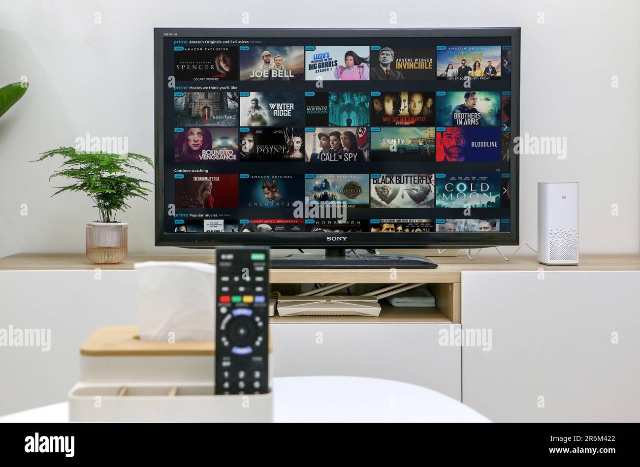 TV remote control and box of tissues on white table, Amazon Prime Video ...