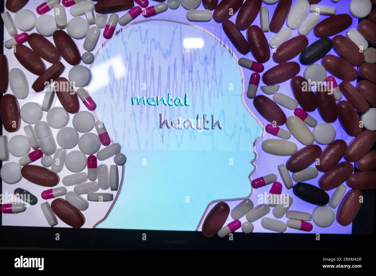 mental health concept with medicines surrounding drawing of a human ...