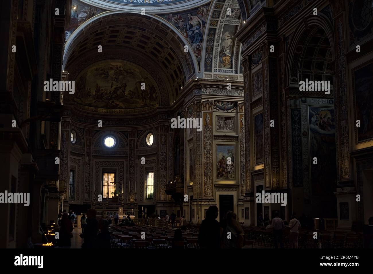 Central nave of San Andrea church with people walking around Stock ...