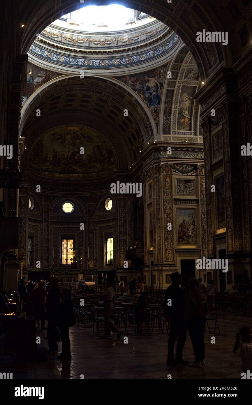 Central nave of San Andrea church with people walking around Stock ...
