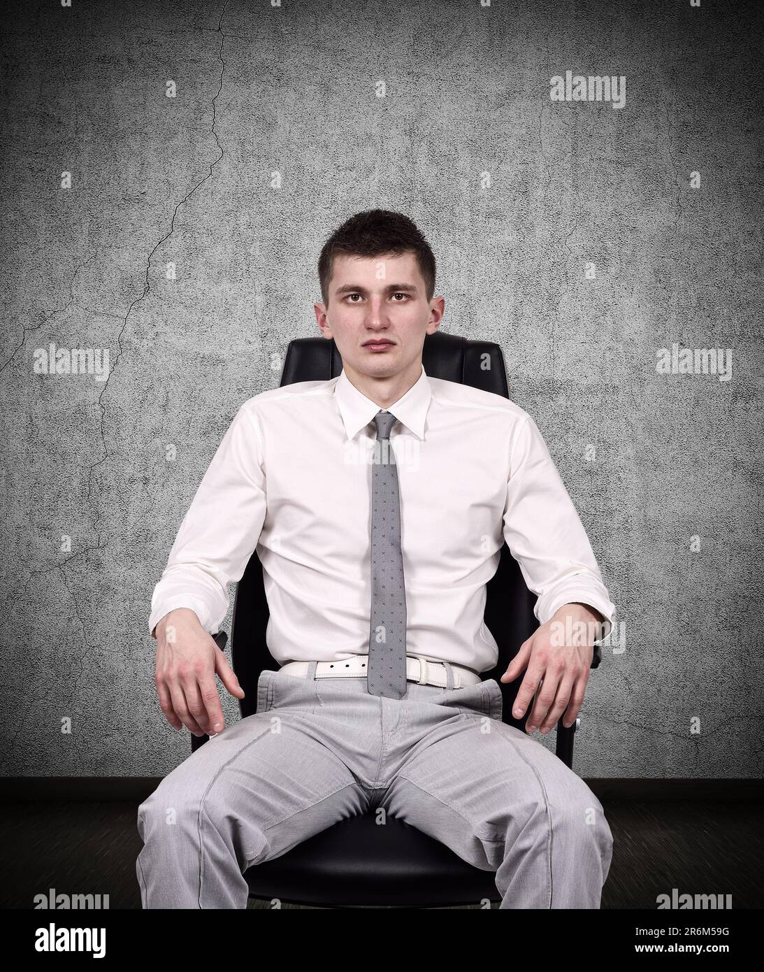 businessman sitting on the office chair in dark room Stock Photo - Alamy