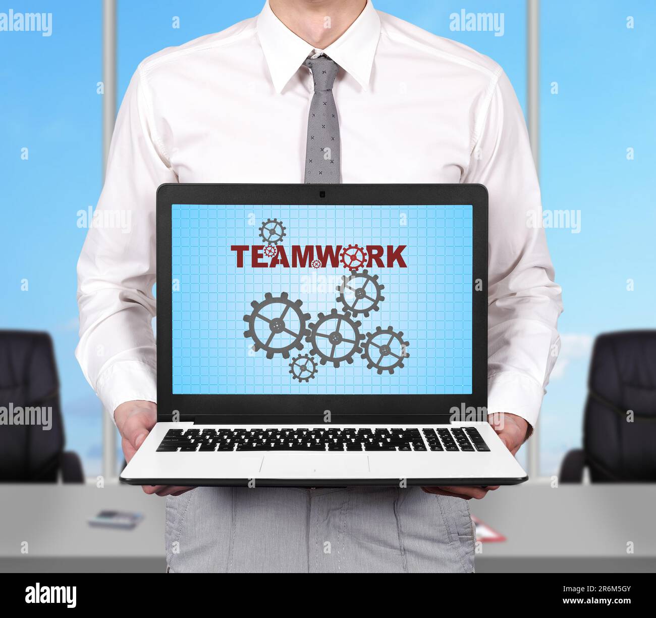 young businessman holding notebook with teamwork scheme Stock Photo - Alamy