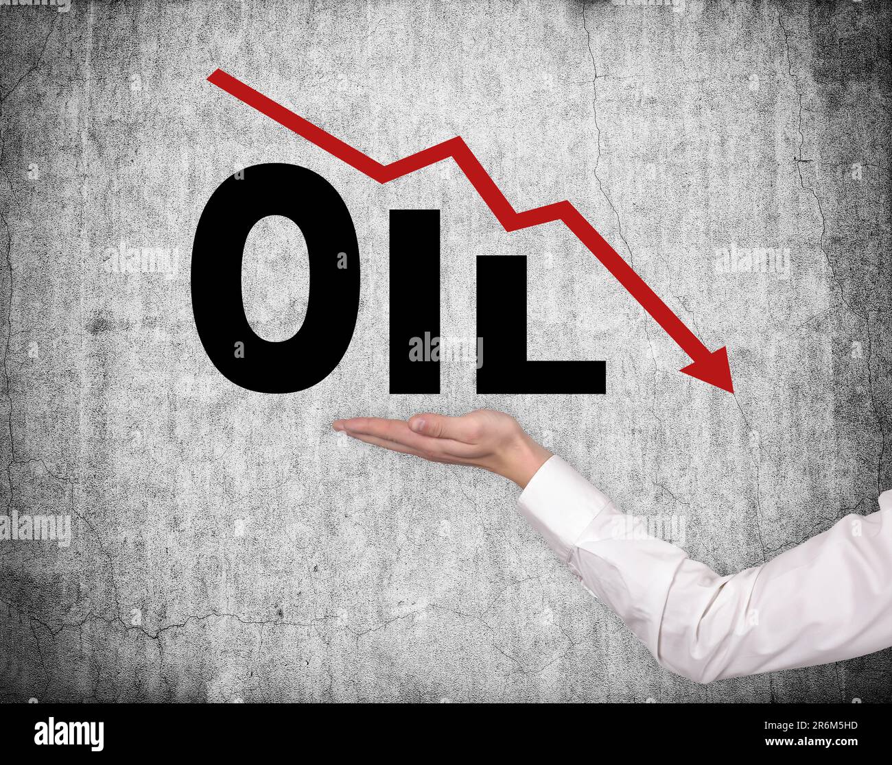 hand holding falling oil chart on gray wall background Stock Photo - Alamy
