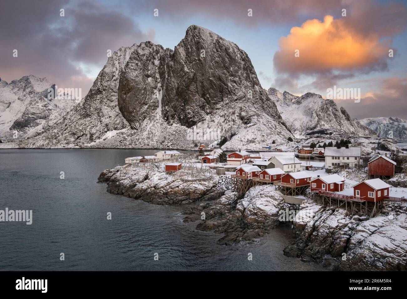 Red Norwegian Rorbuer Huts and Festhaeltinden mountain in winter ...